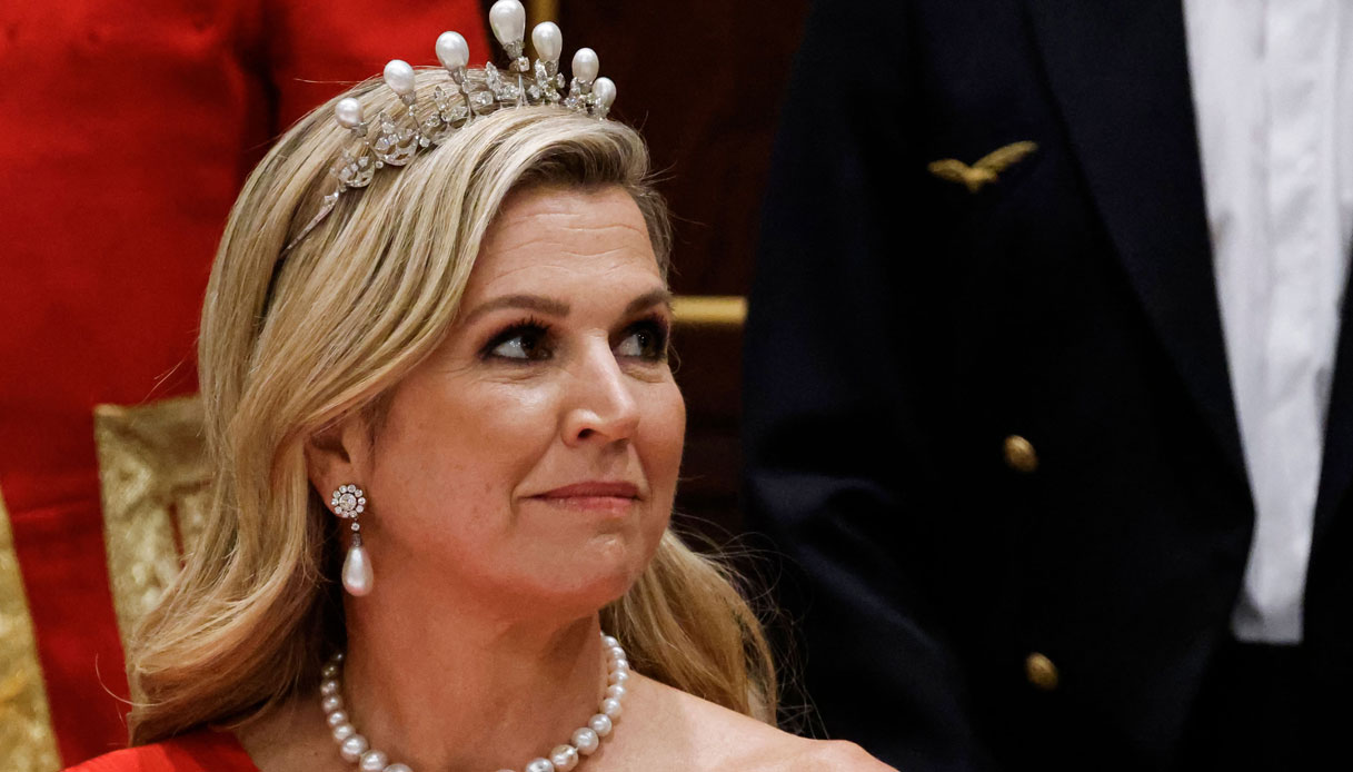 La Regina Maxima seduce Emmanuel Macron: abito rosso ed effetto nude